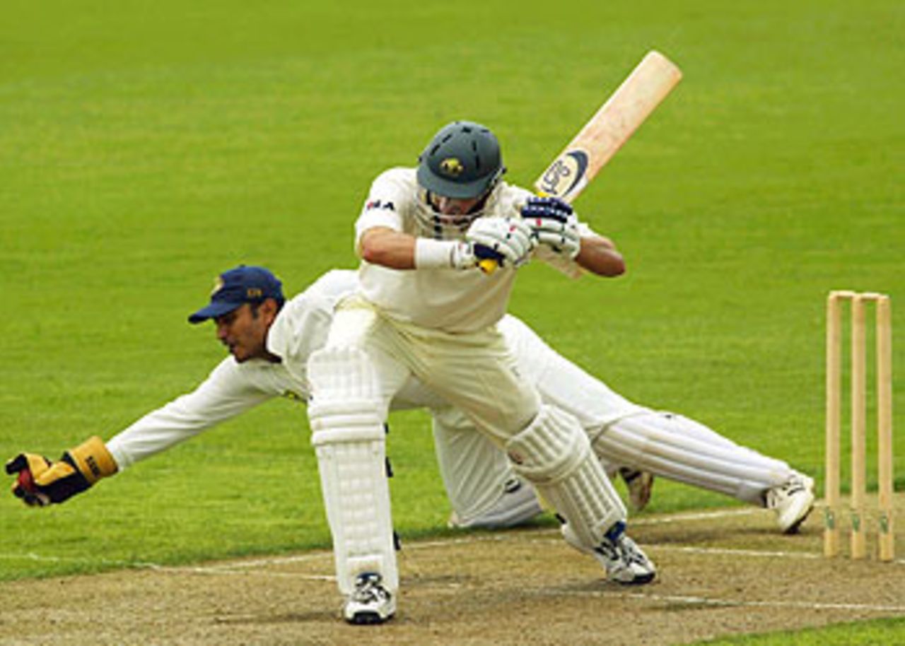 Deep Dasgupta makes a valiant take as Mike Hussey poses elegantly ...