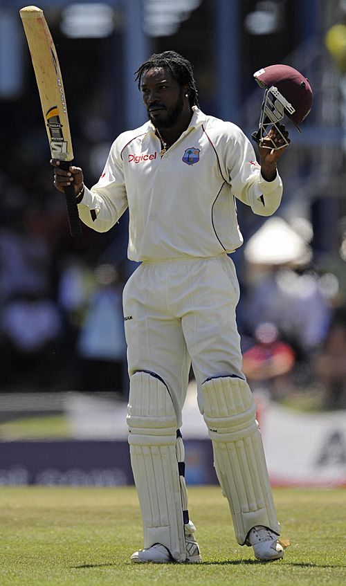 Chris Gayle raises his bat on reaching his hundred but retired hurt ...