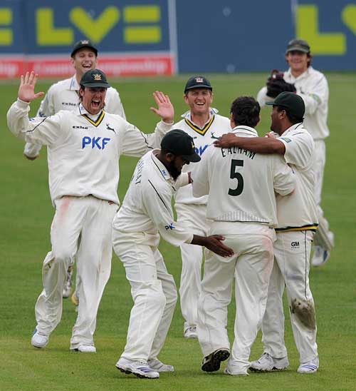 Mark Ealham is congratulated after removing Daryl Mitchell ...