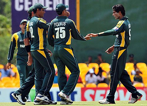 Mohammad Aamer is congratulated after picking up a wicket ...