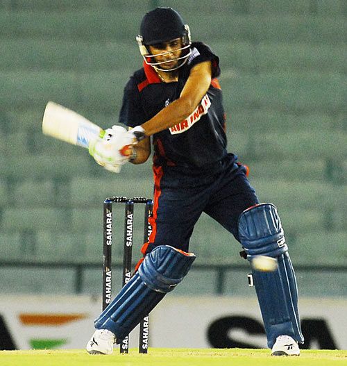 Manvinder Bisla gets set to heave the ball towards midwicket ...