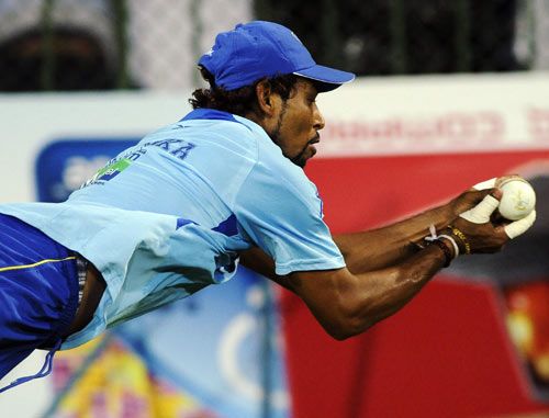 Tillakaratne Dilshan takes a diving catch during a training session ...