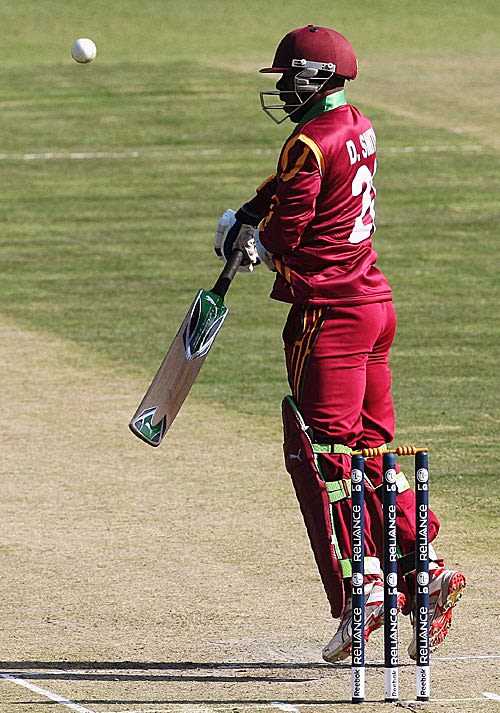 Devon Smith is surprised by a short one, and ends up playing it to slip ...