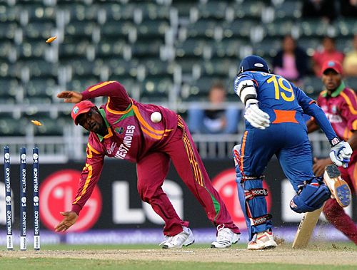 A direct throw from David Bernard has Rahul Dravid short of his crease ...