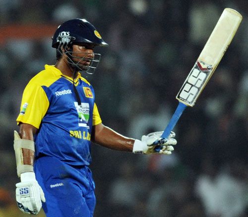 Kumar Sangakkara raises his bat on reaching his half-century ...
