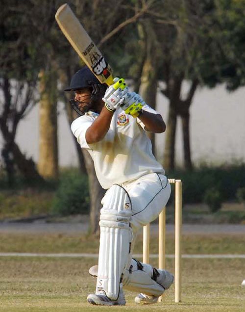 Rajshahi's Farhad Hossain drives during his century against Chittagong ...