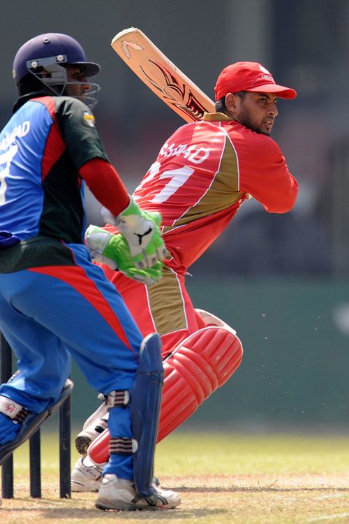 Abdool Samad plays through the off side as Mohammad Shahzad looks on ...