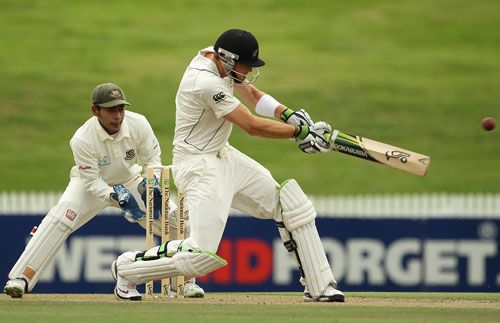 Martin Guptill plays one through the legside as Mushfiqur Rahim watches ...