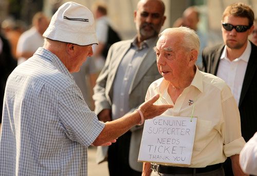 A fan wears a sign around his neck asking for a ticket | ESPNcricinfo.com
