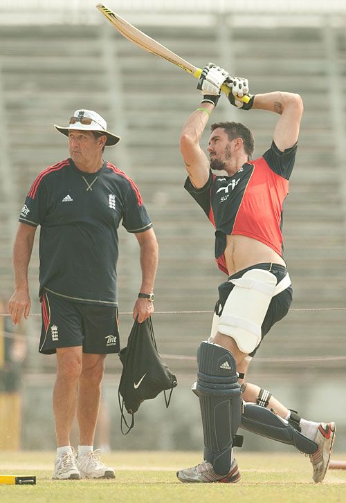Kevin Pietersen aims an expansive drive in practice while Graham Gooch ...