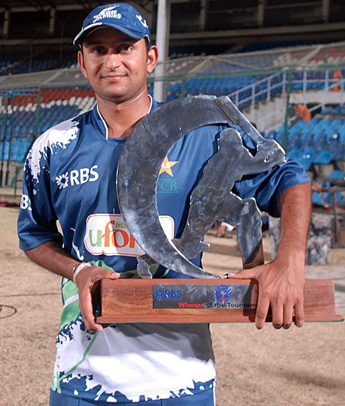 Sind Dolphins captain Faisal Iqbal poses with the winners' trophy ...