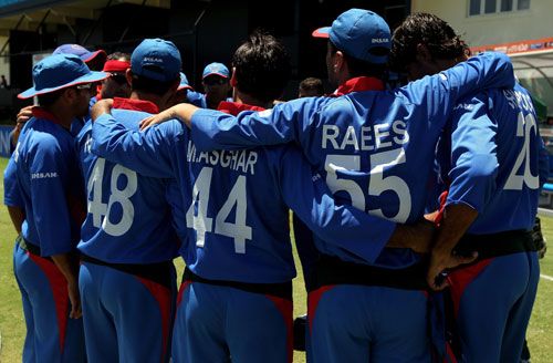 The Afghanistan team huddles together before taking the field ...