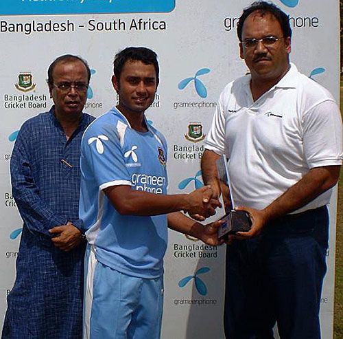 Bangladesh Academy captain Mithun Ali collects the runners-up trophy ...
