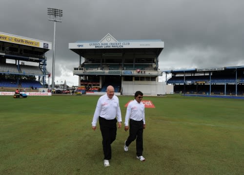 Umpires Steve Davis and Asad Rauf inspect the pitch before the start of ...