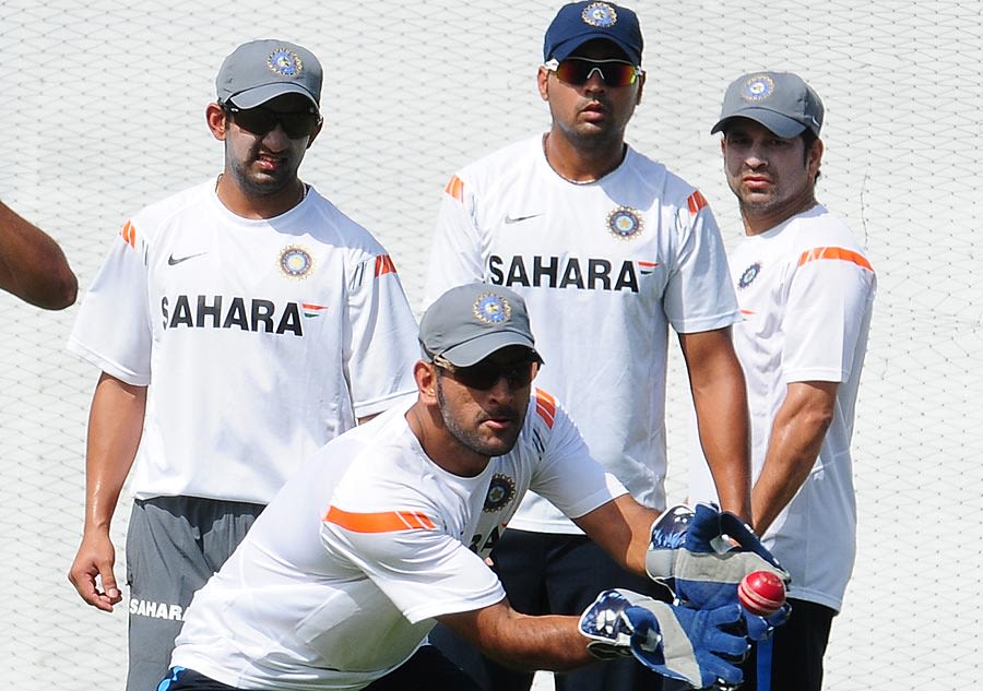 MS Dhoni collects the ball during fielding practice at the Premadasa ...