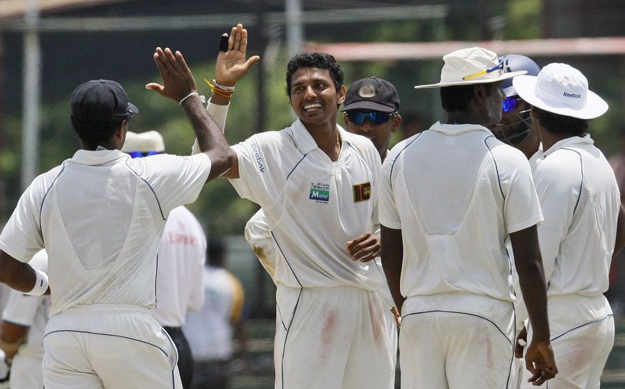 Suraj Randiv celebrates the dismissal of Rahul Dravid with his team ...