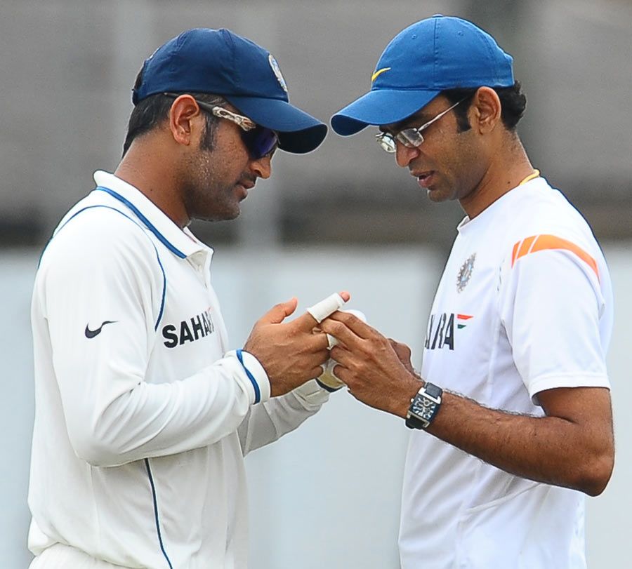 MS Dhoni has his finger examined by Indian physiotherapist Nitin Patel ...