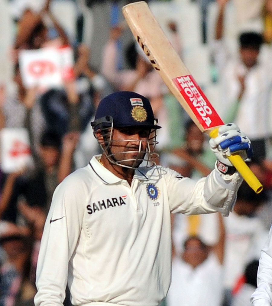 Virender Sehwag celebrates after reaching his half-century ...