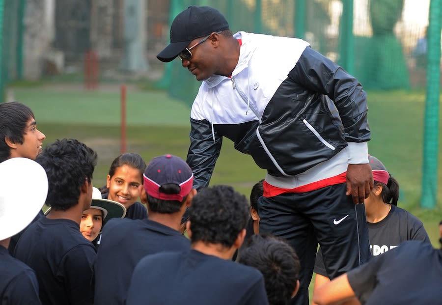Brian Lara meets children during a coaching clinic at the Feroz Shah ...