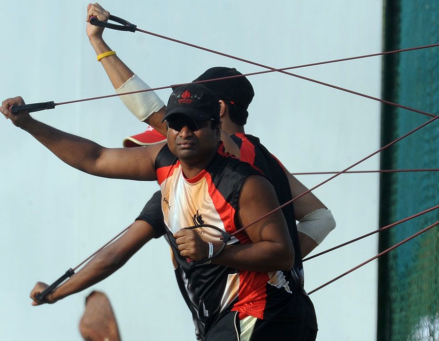 Canada's Balaji Rao stretches with team-mates during practice ...