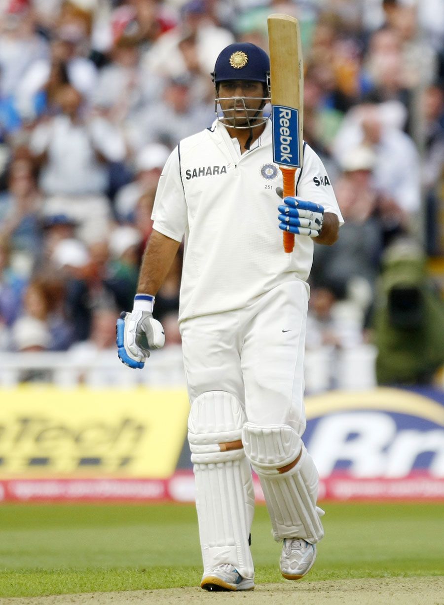 MS Dhoni raises his bat after getting to his half-century ...