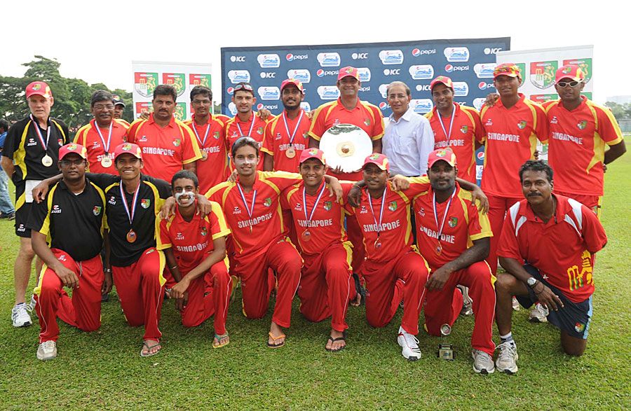 Singapore pose with the ICC World Cricket League Division Five title ...