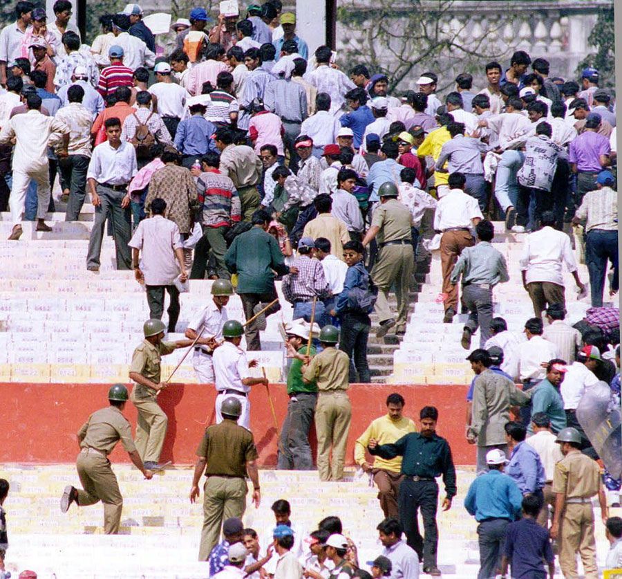 The Calcutta police chase spectators out of the stadium to clear the ...