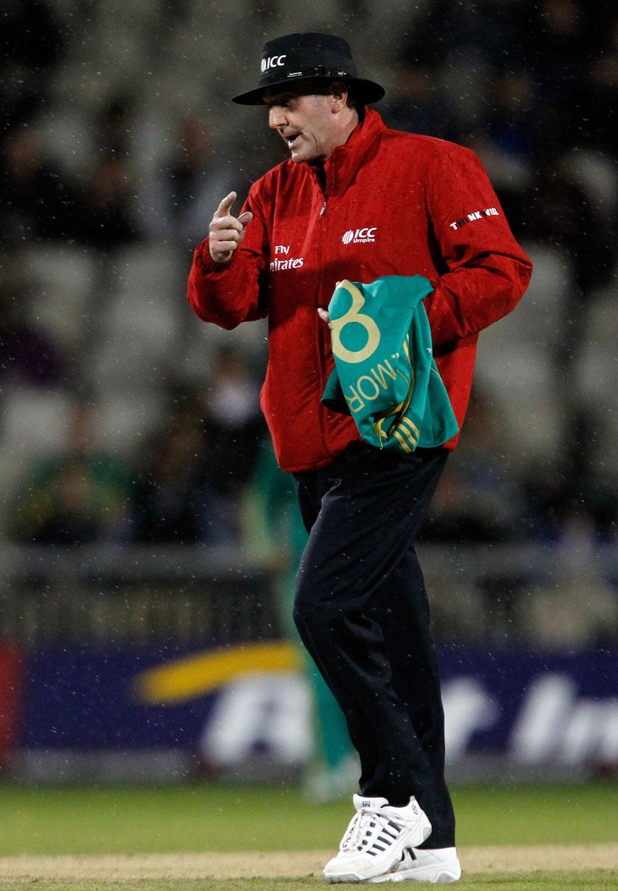 Umpire Rob Bailey gives the final signal to leave the field for good ...