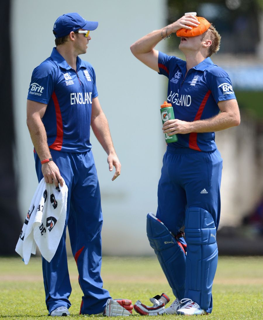 Luke Wright cools off with an ice pack while 12th man Michael Lumb ...