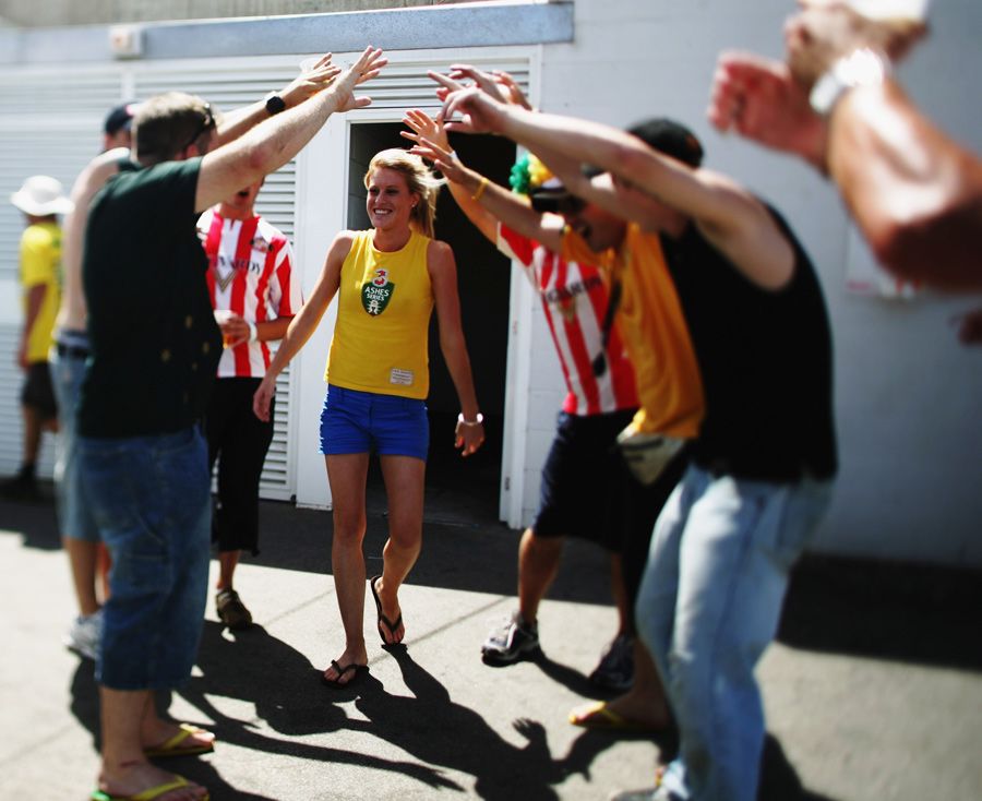 A group of male fans give a guard of honour to a female fan ...