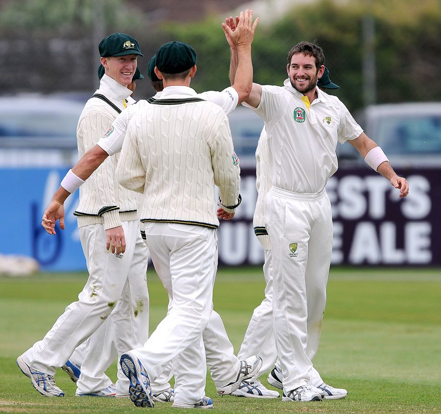 Chadd Sayers (right) celebrates a wicket with his team-mates ...