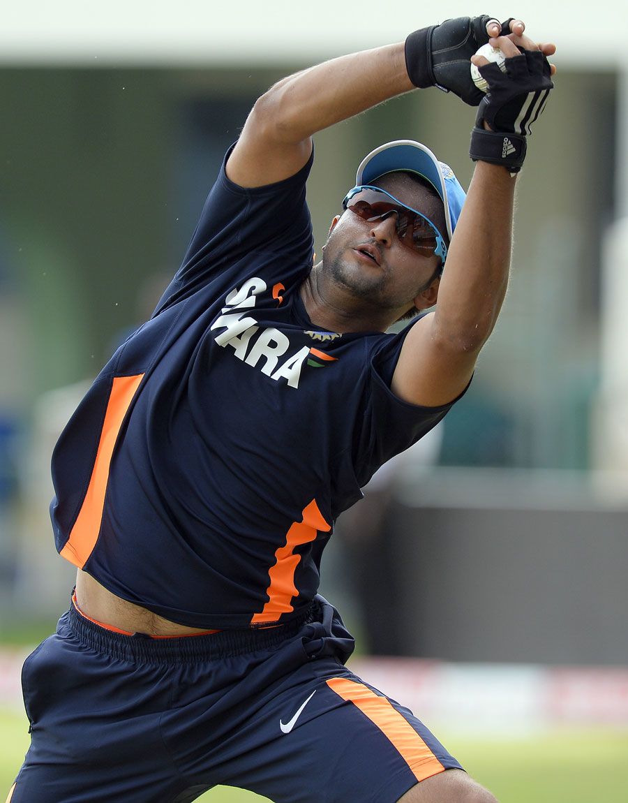 Suresh Raina takes a leaping catch during a practice session ...