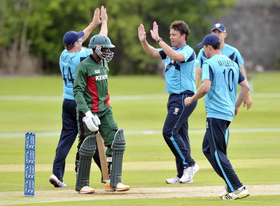 Neil Carter celebrates with team-mates after dismissing Alex Obanda ...