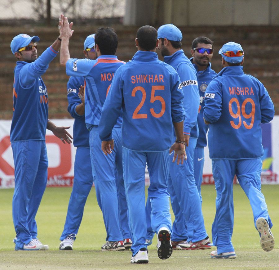 The Indian players celebrate the wicket of Hamilton Masakadza ...