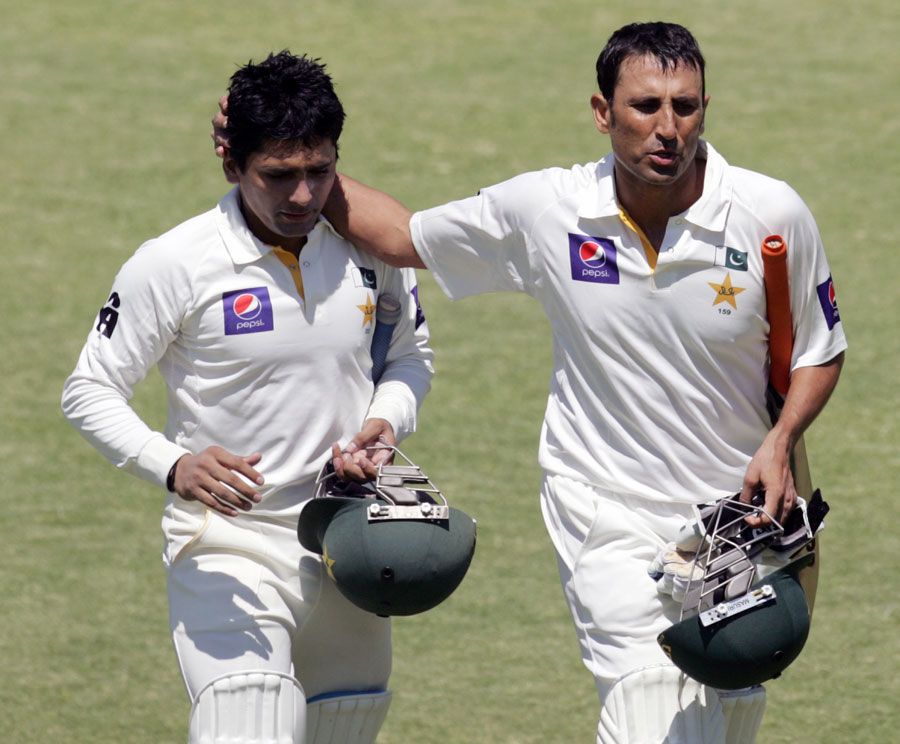 Younis Khan and Adnan Akmal walk off the pitch for the lunch break ...