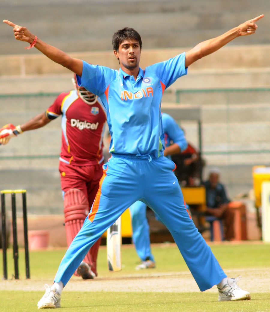 Rahul Sharma strikes a pose after knocking over another batsman ...