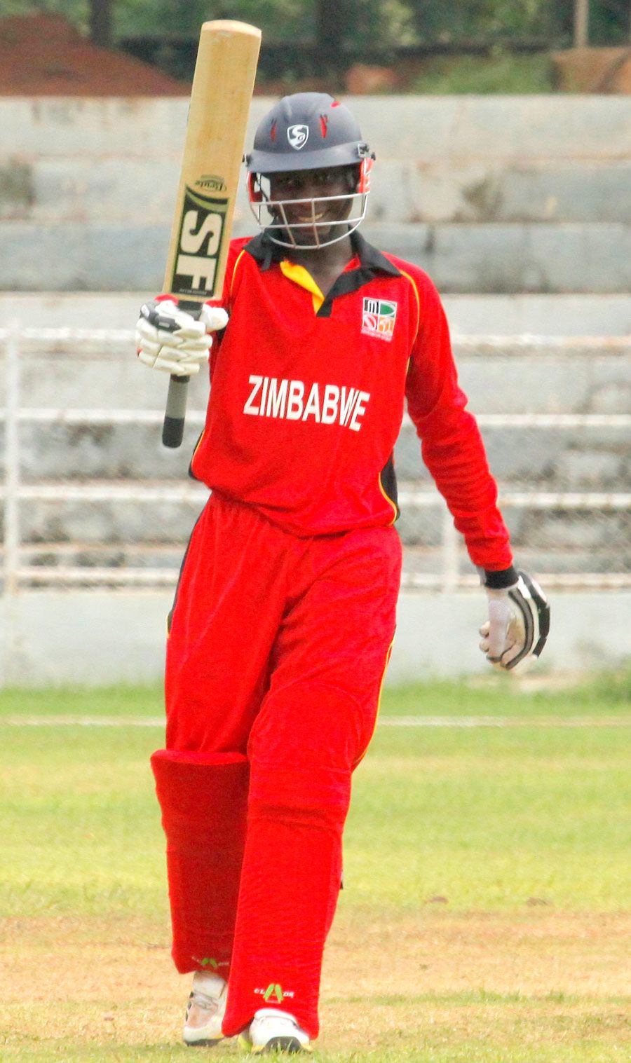 Clive Chitumba raises his bat after hitting fifty | ESPNcricinfo.com