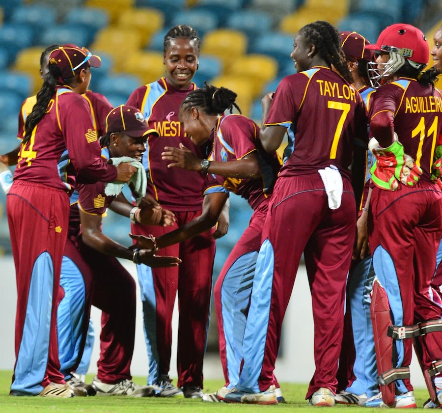 Shaquana Quintyne is mobbed by her teammates after her maiden five-for ...