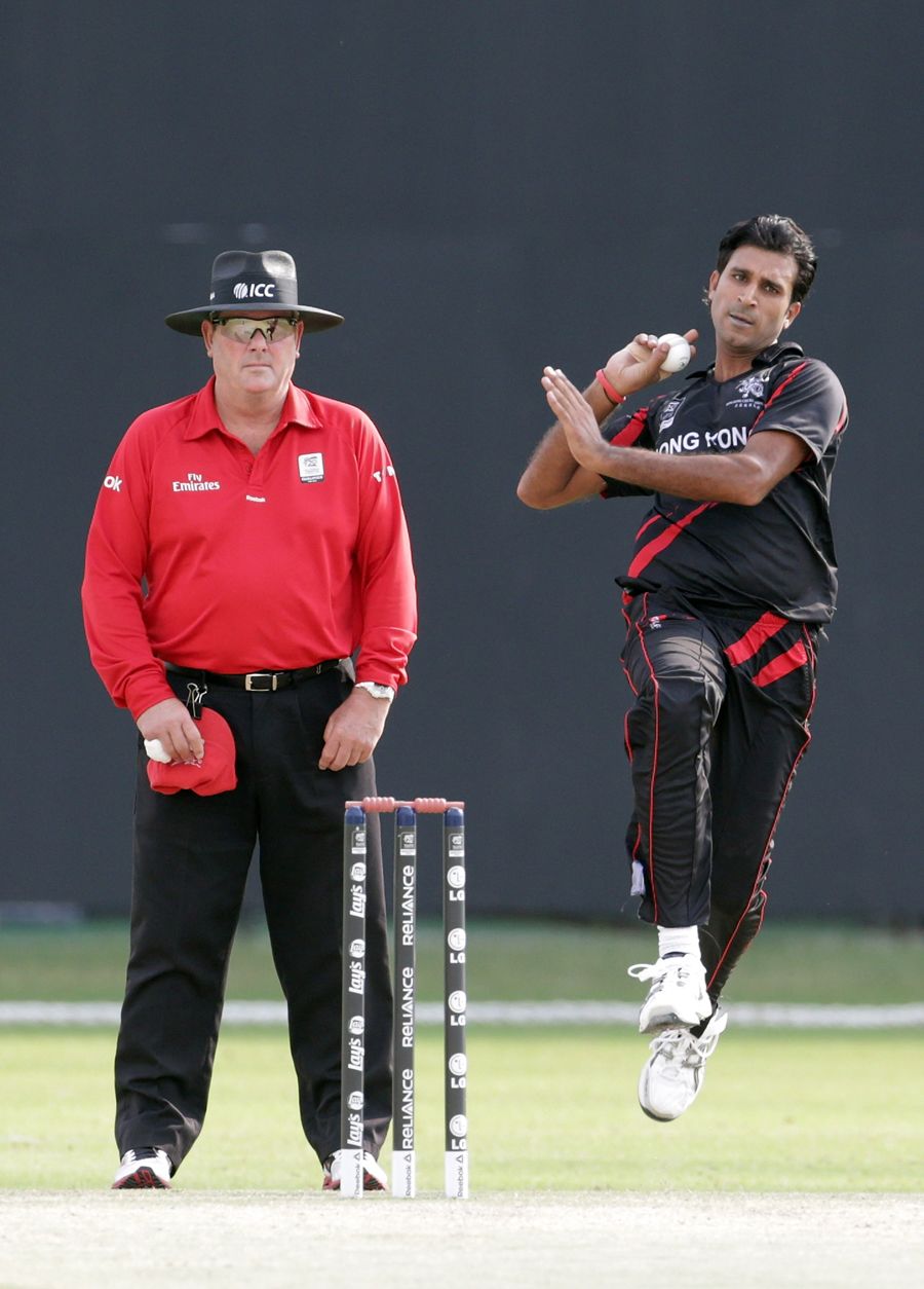Tanwir Afzal coming in to bowl against Ireland along side umpire Derek Walker | ESPNcricinfo.com