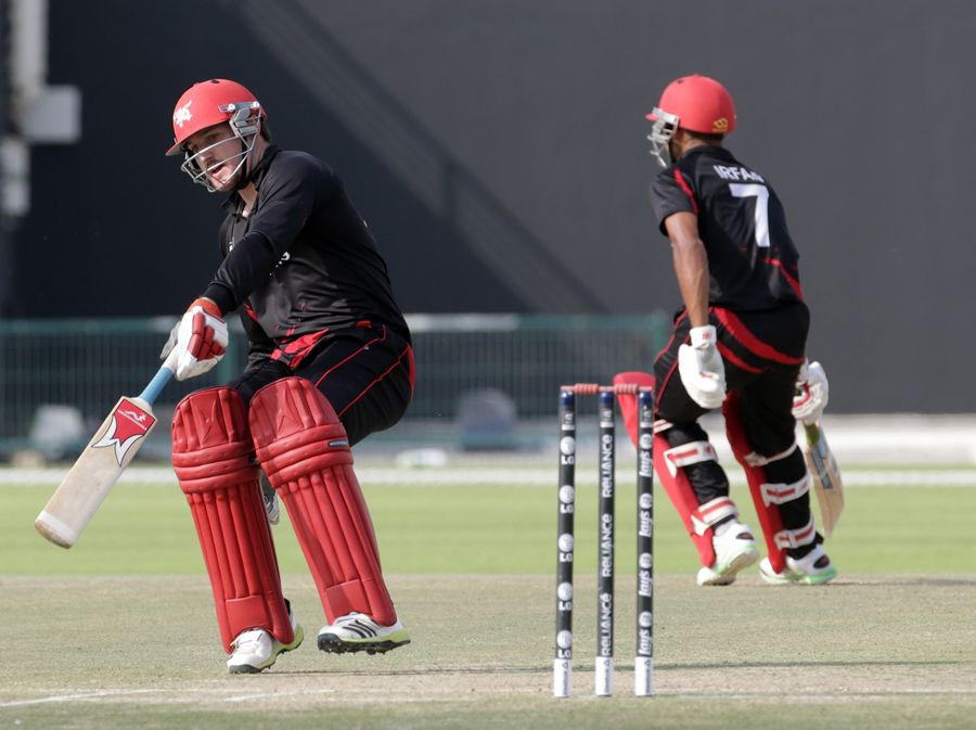 Jamie Atkinson (L) takes runs with his batting partner Irfan Ahmed ...