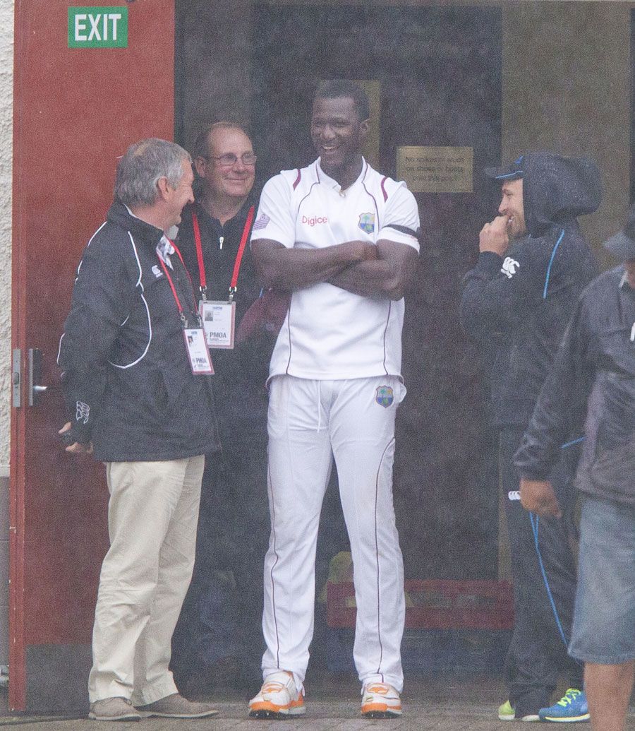 Darren Sammy takes shelter during a heavy shower | ESPNcricinfo.com