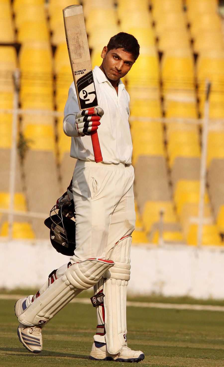 Nitin Saini sneaks a look at the camera after reaching a century | ESPNcricinfo.com