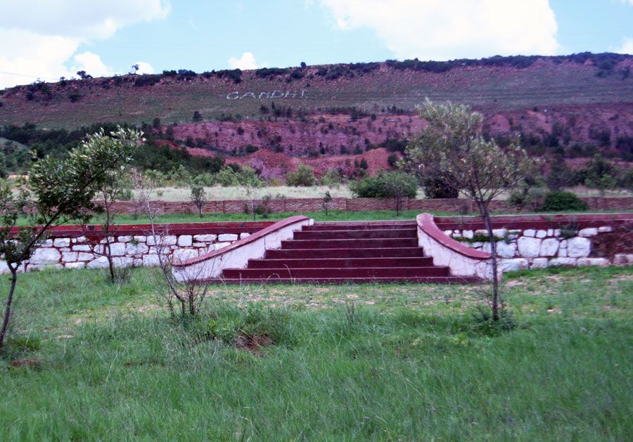 A stone inscription dedicated to Mahatma Gandhi on a hill overlooking ...
