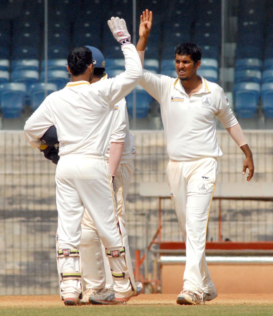Malolan Rangarajan celebrates a wicket with his team-mates ...