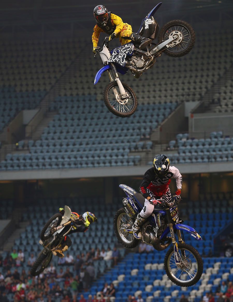 A trio of motorcycle stunt riders engage in some daredevilry ...