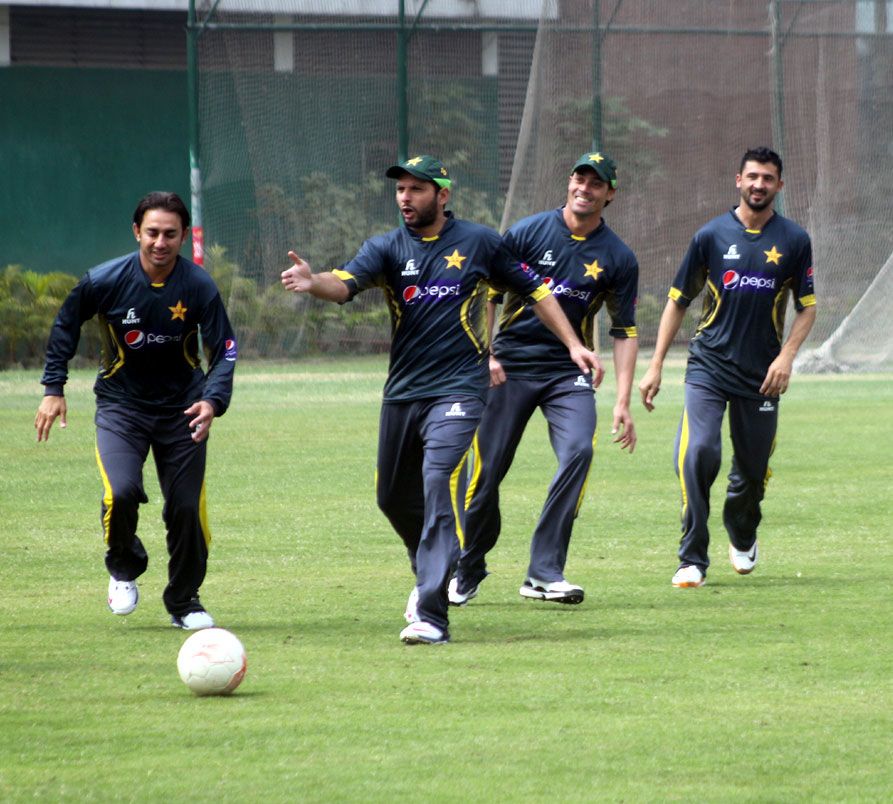 The Pakistan players kick about a football during training ...