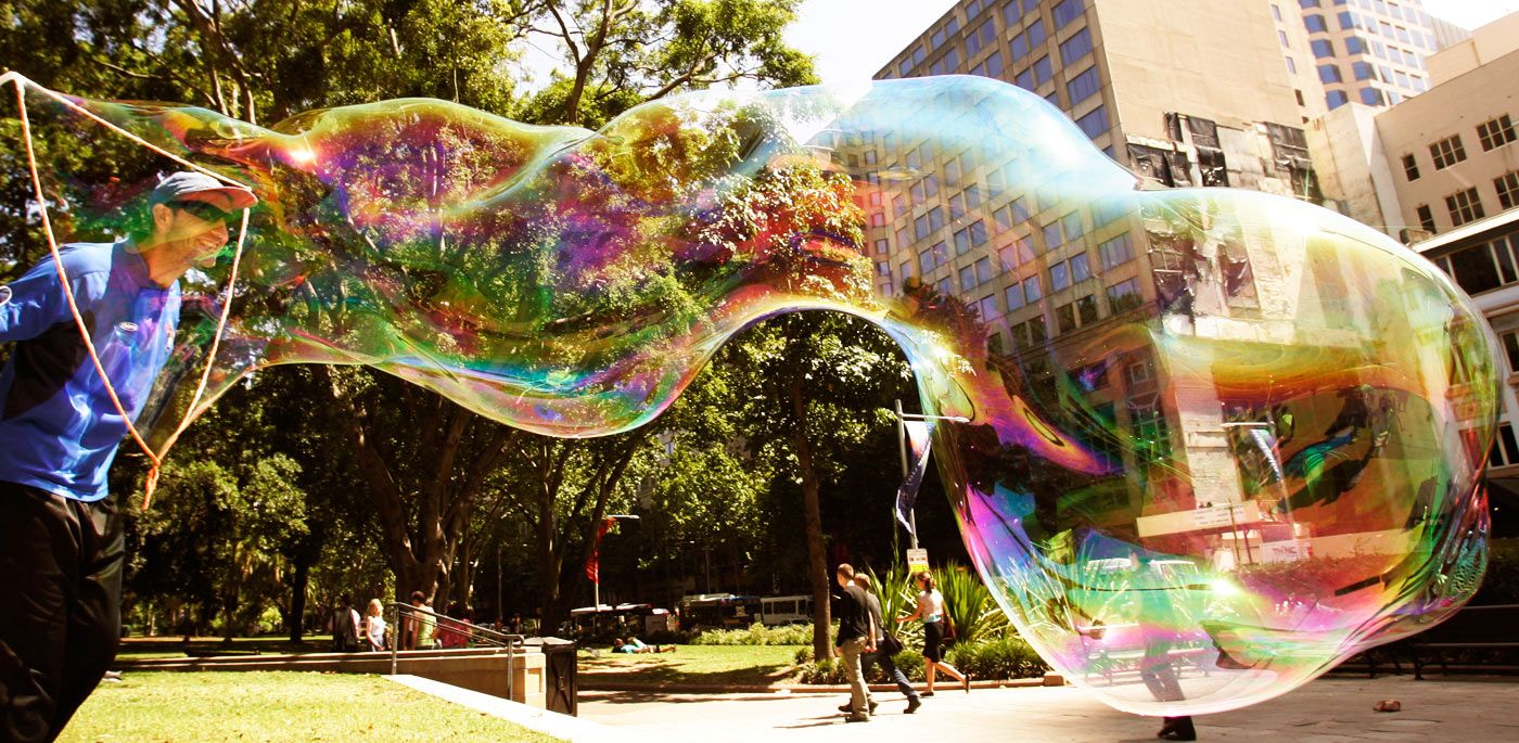 A street performer demonstrates his bubble-blowing skills in Hyde Park ...