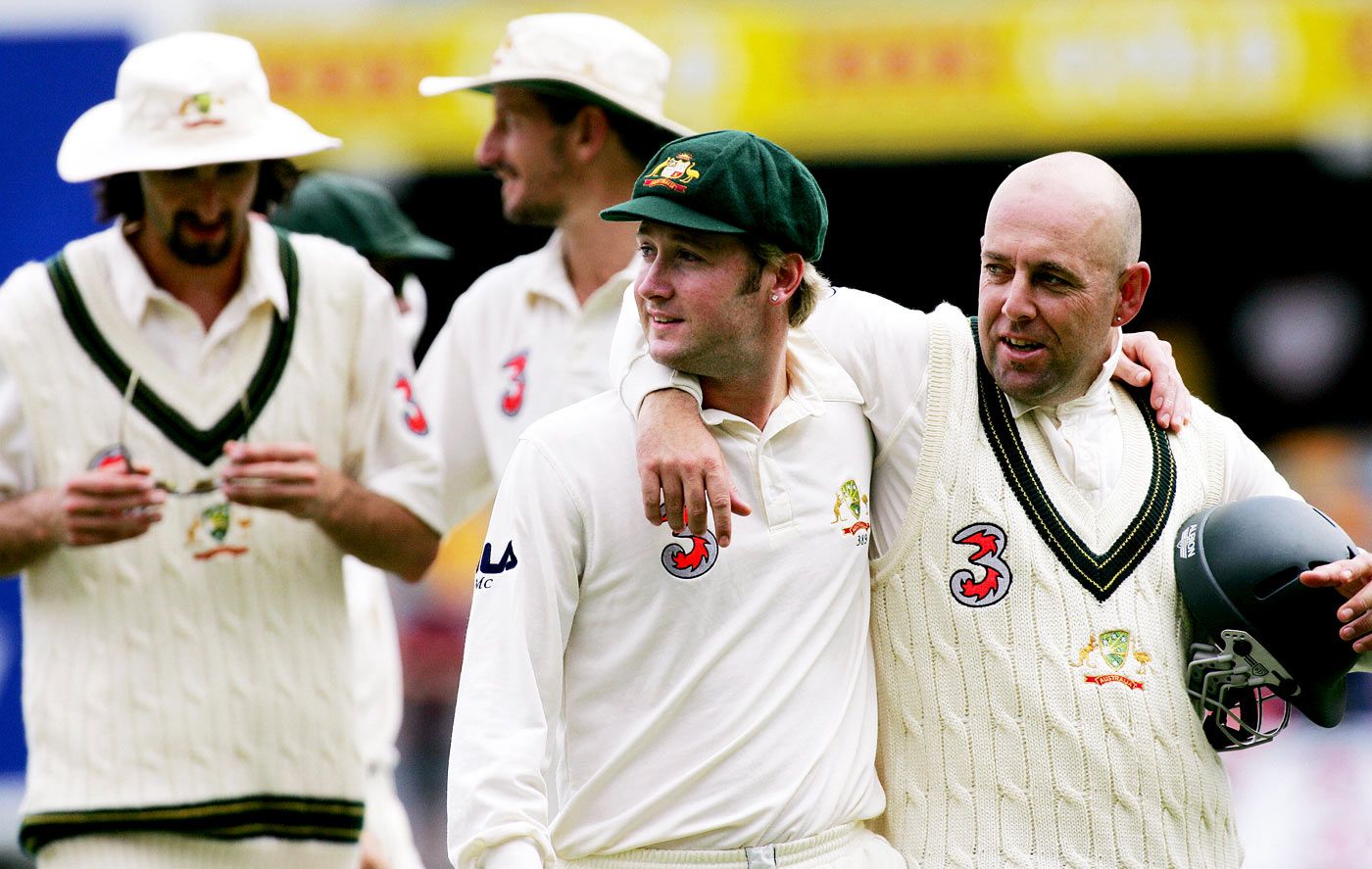 Michael Clarke and Darren Lehmann walk arm in arm after the victory ...