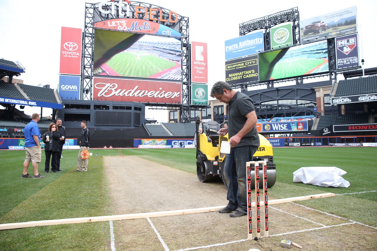 Visiting curator Mark Perham of Auckland makes final preparations to ...