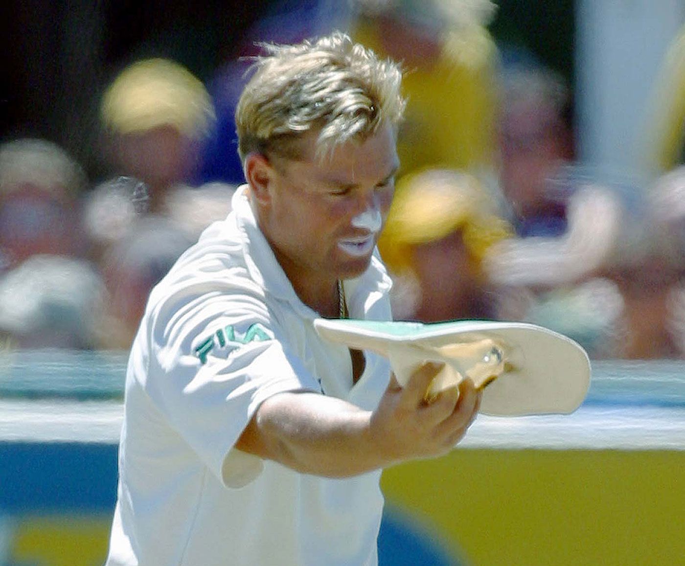 Shane Warne takes his hat off to the crowd after taking a six-wicket ...